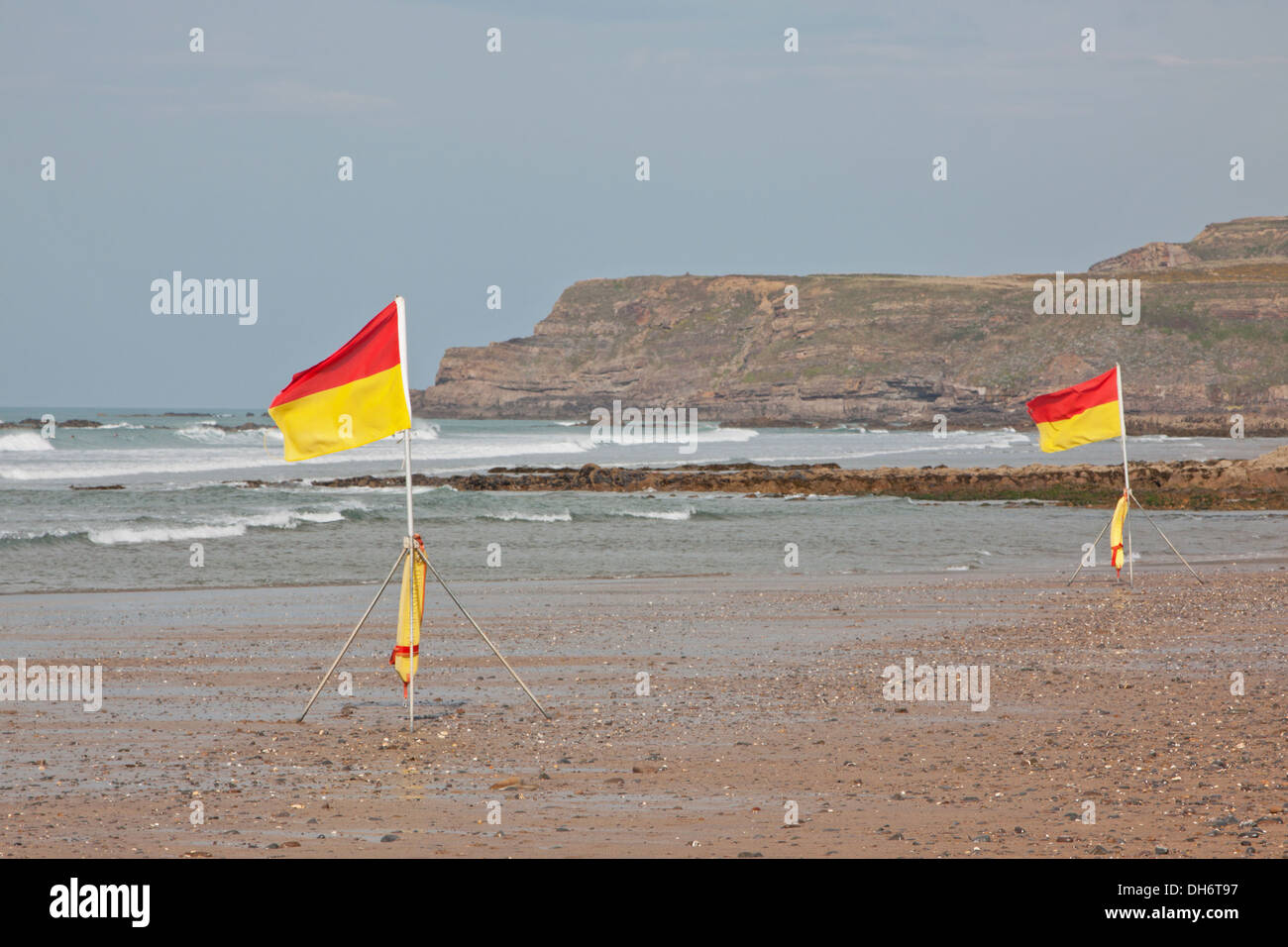 Flags indicating safe bathing and surfing areas on a Cornish beach UK ...