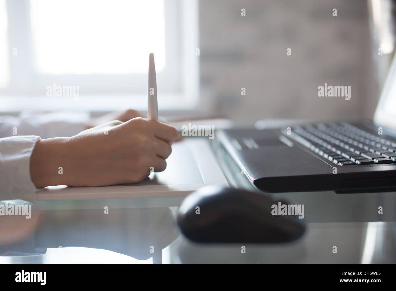 Female designer using graphics pad in office Stock Photo - Alamy