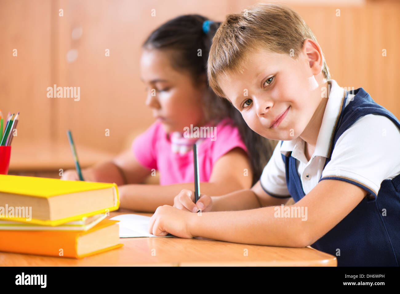 Portrait of cute schoolboy during lesson in classroom at school Stock ...