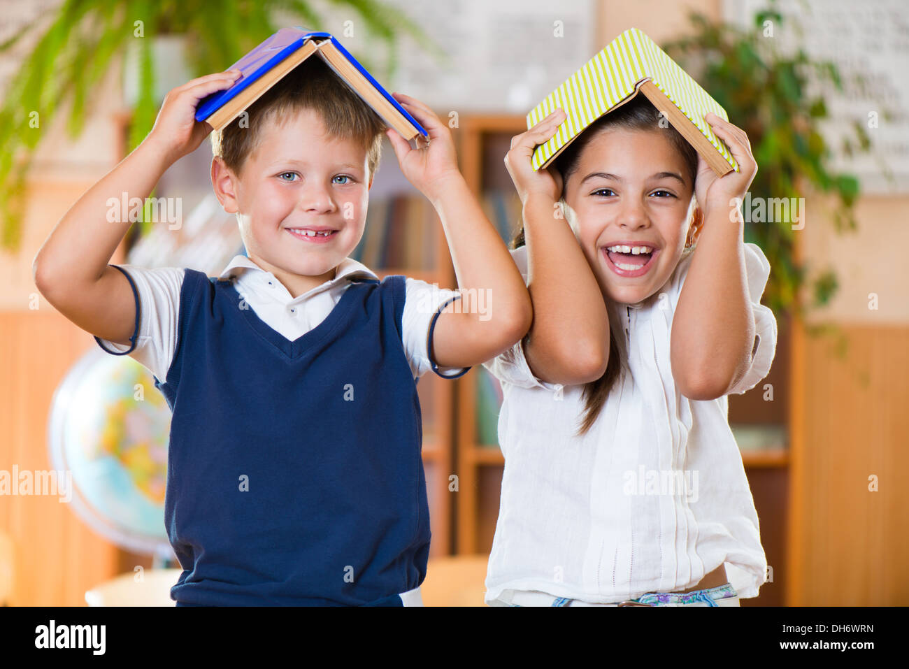 Two happy schoolchildren have fun in classroom at school Stock Photo ...