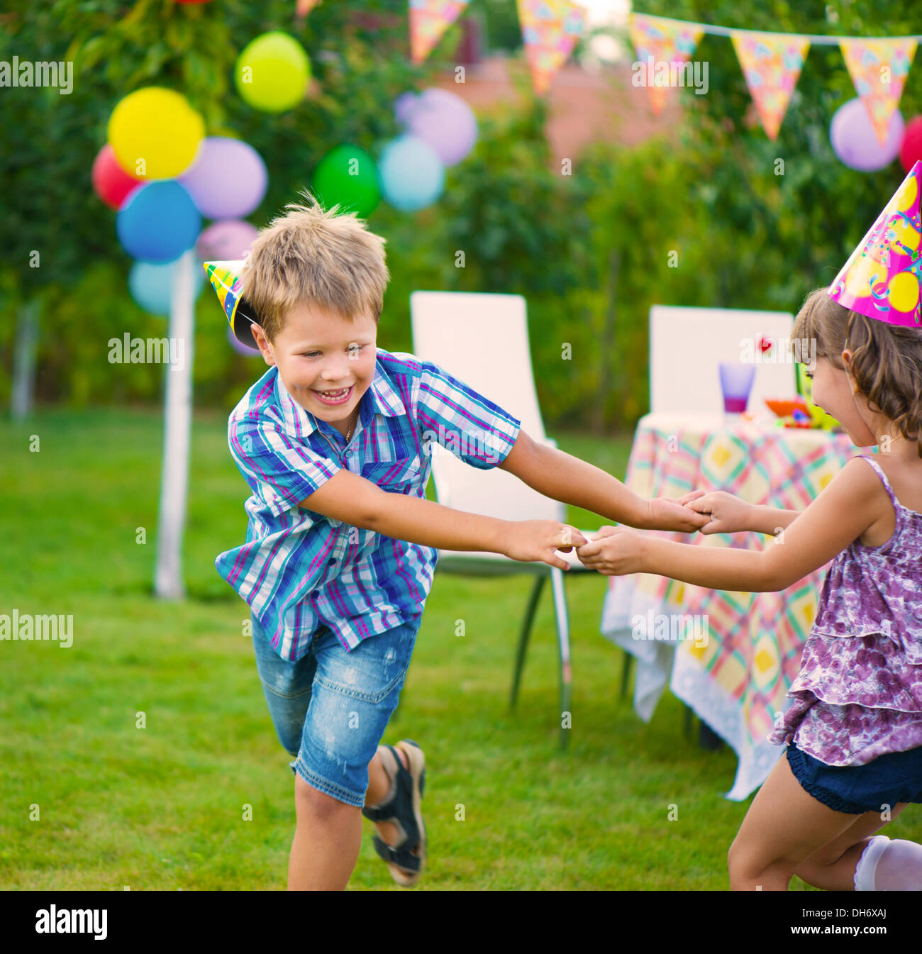 Two little kids celebrating birthday dancing roundelay Stock Photo - Alamy