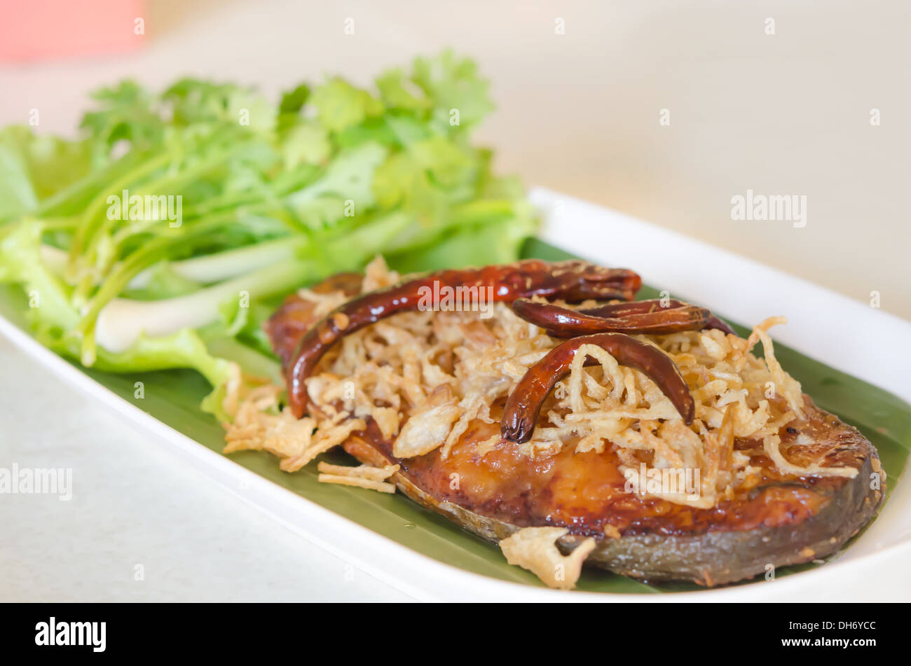 Fried pickled fish , onion and chili served with fresh vegetable on ...