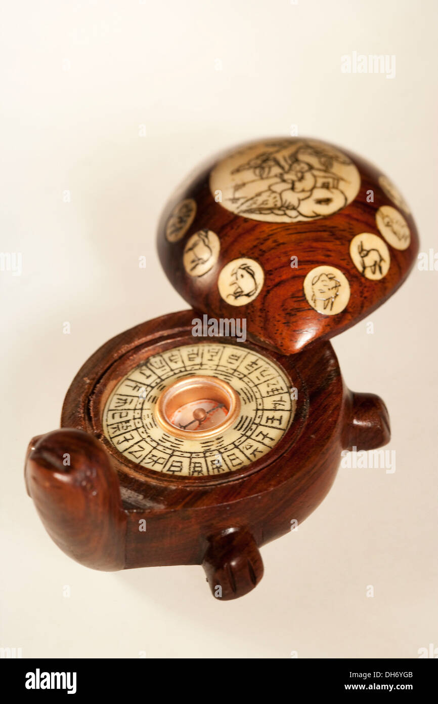 Compass inlaid in a wooden turtle Stock Photo - Alamy