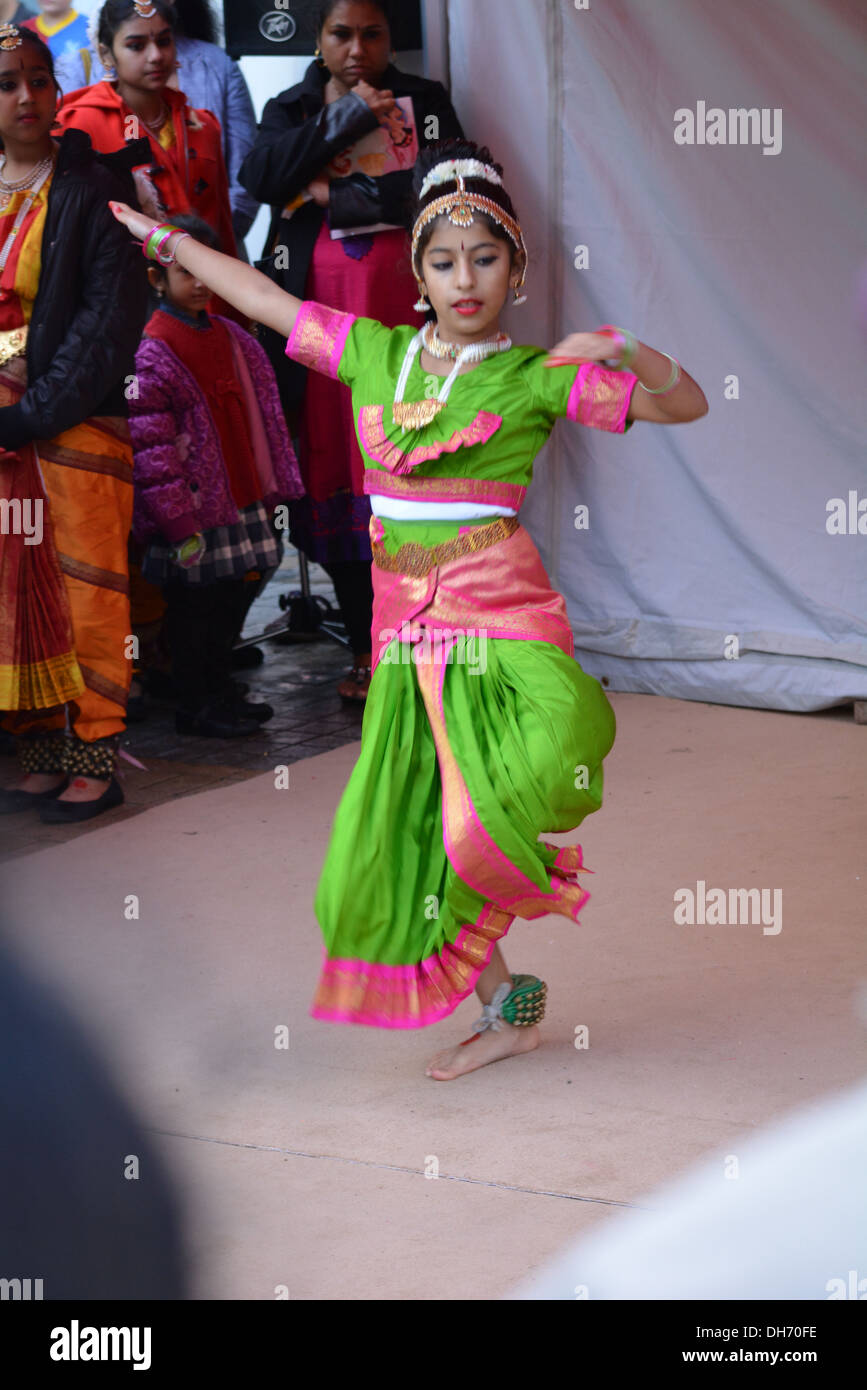 Young Hindu girl doing traditional dancing in the High street in ...