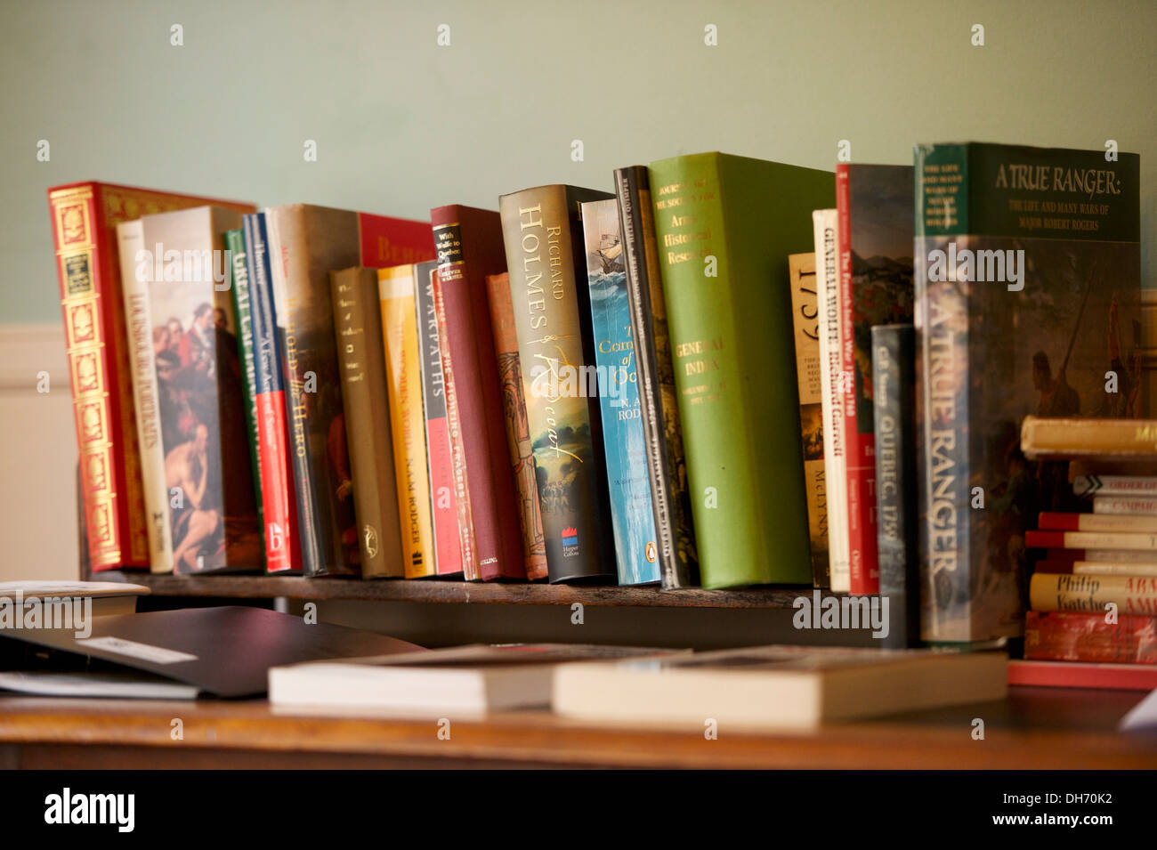 Books standing on desk shelf Stock Photo - Alamy