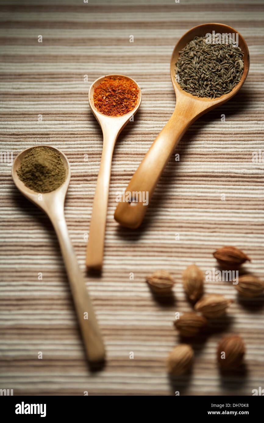 Three wood spoons filled with Chinese cooking condiments Stock Photo ...