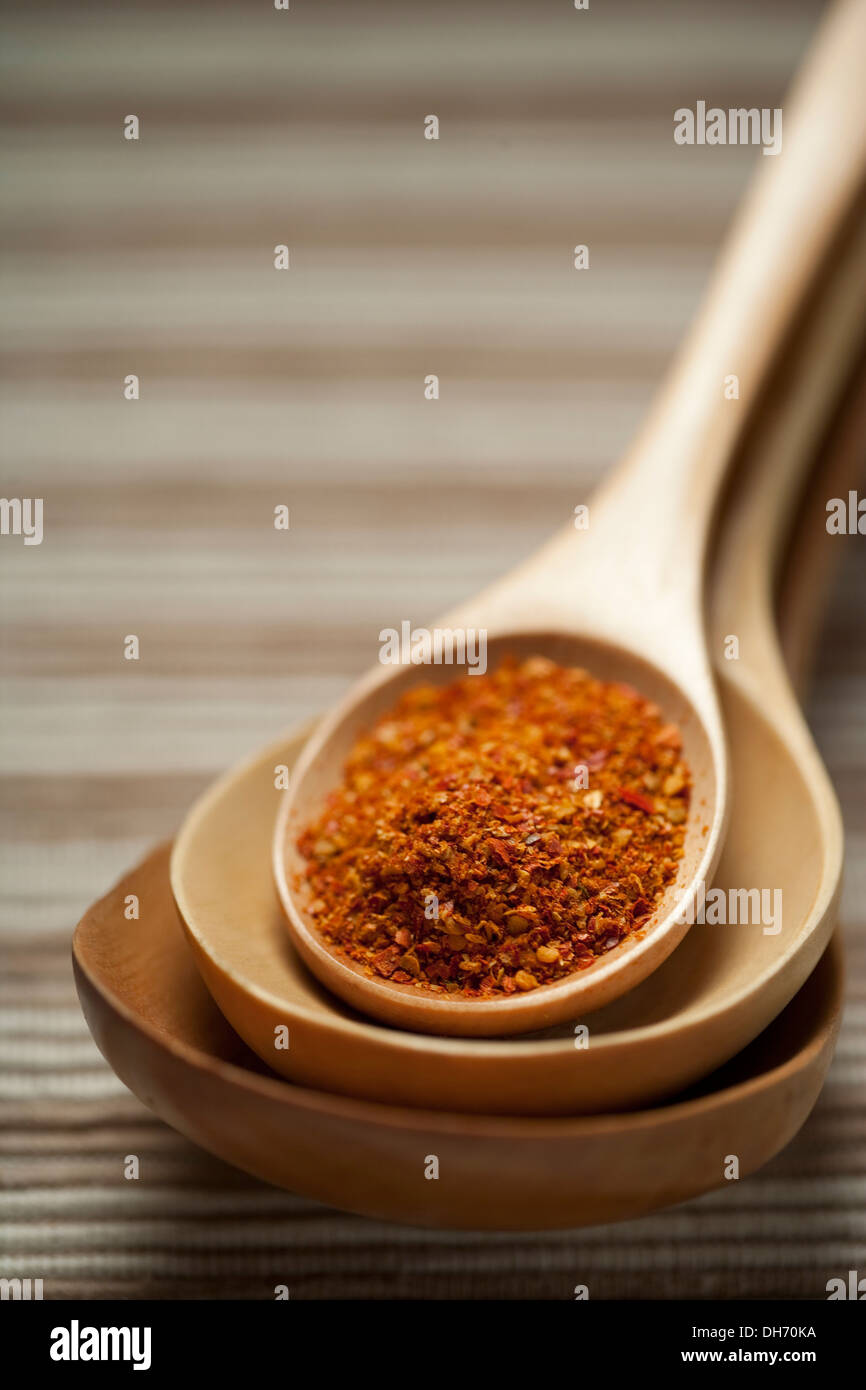 Stacked wood spoons filled with red chilli pepper powder Stock Photo ...
