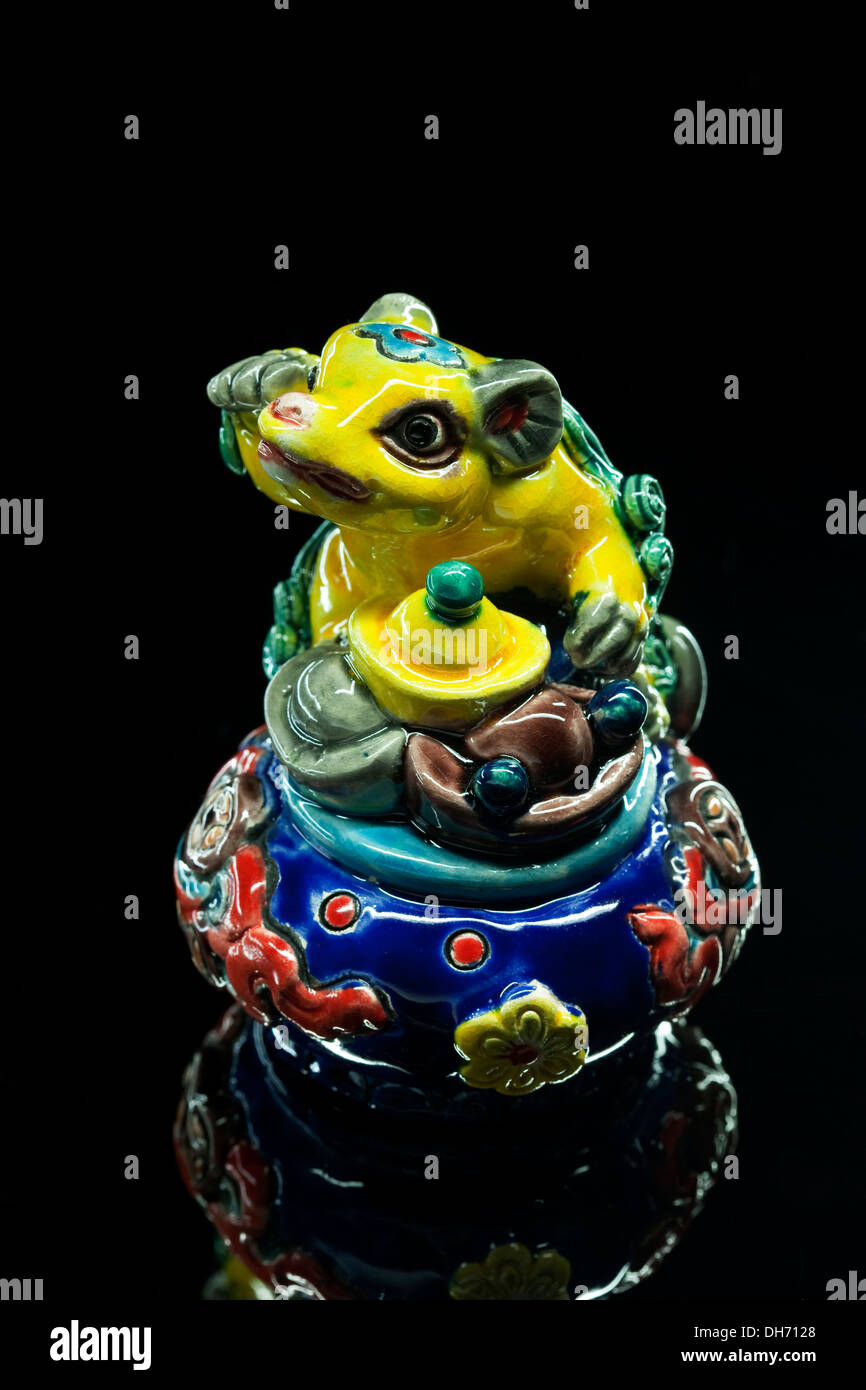 Traditional sculpture of Chinese zodiac sign, Rat sitting on the jar ...