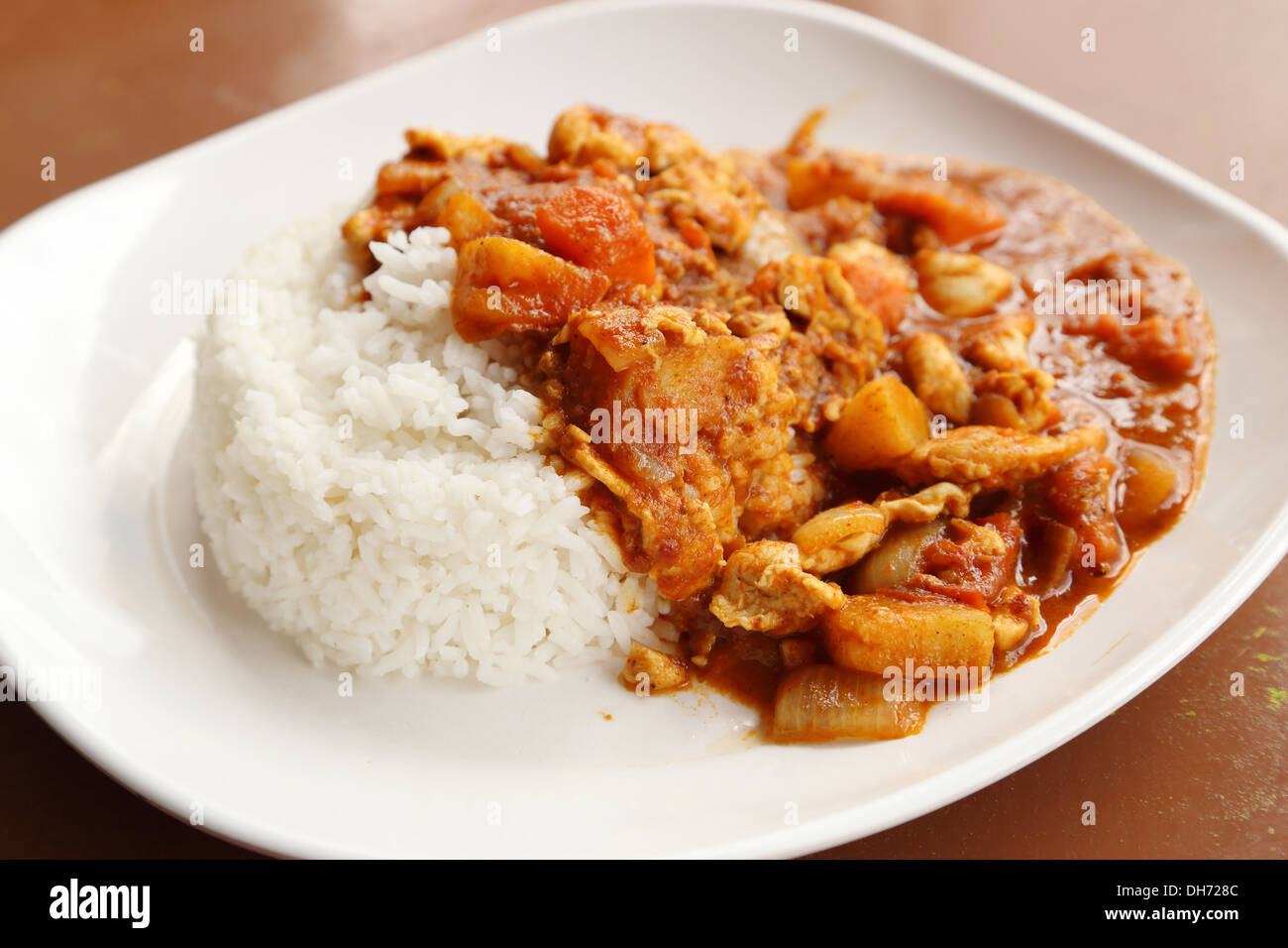 spicy chicken curry and rice on dish Stock Photo - Alamy