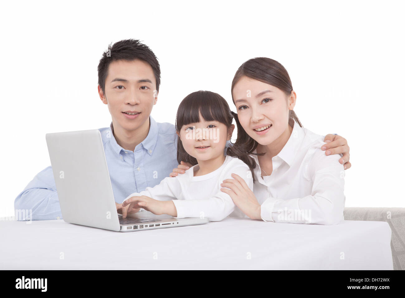 A family of three looking at the computer Stock Photo - Alamy