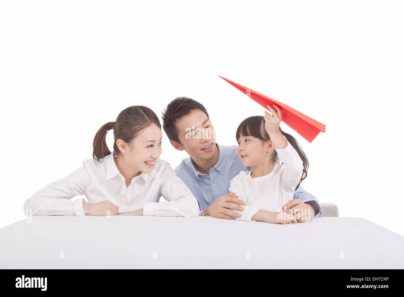 A family of three playing paper airplane Stock Photo - Alamy