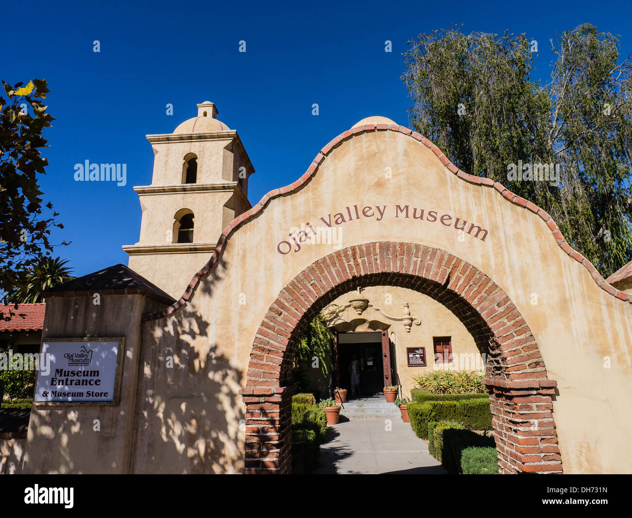 Archway entrance to Ojai Valley Museum framing the bell tower and cross ...