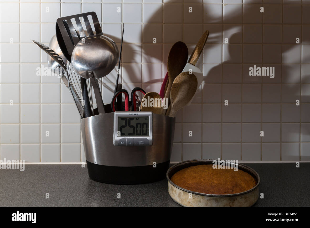 Kitchen utensils and a fresh baked cake Stock Photo - Alamy