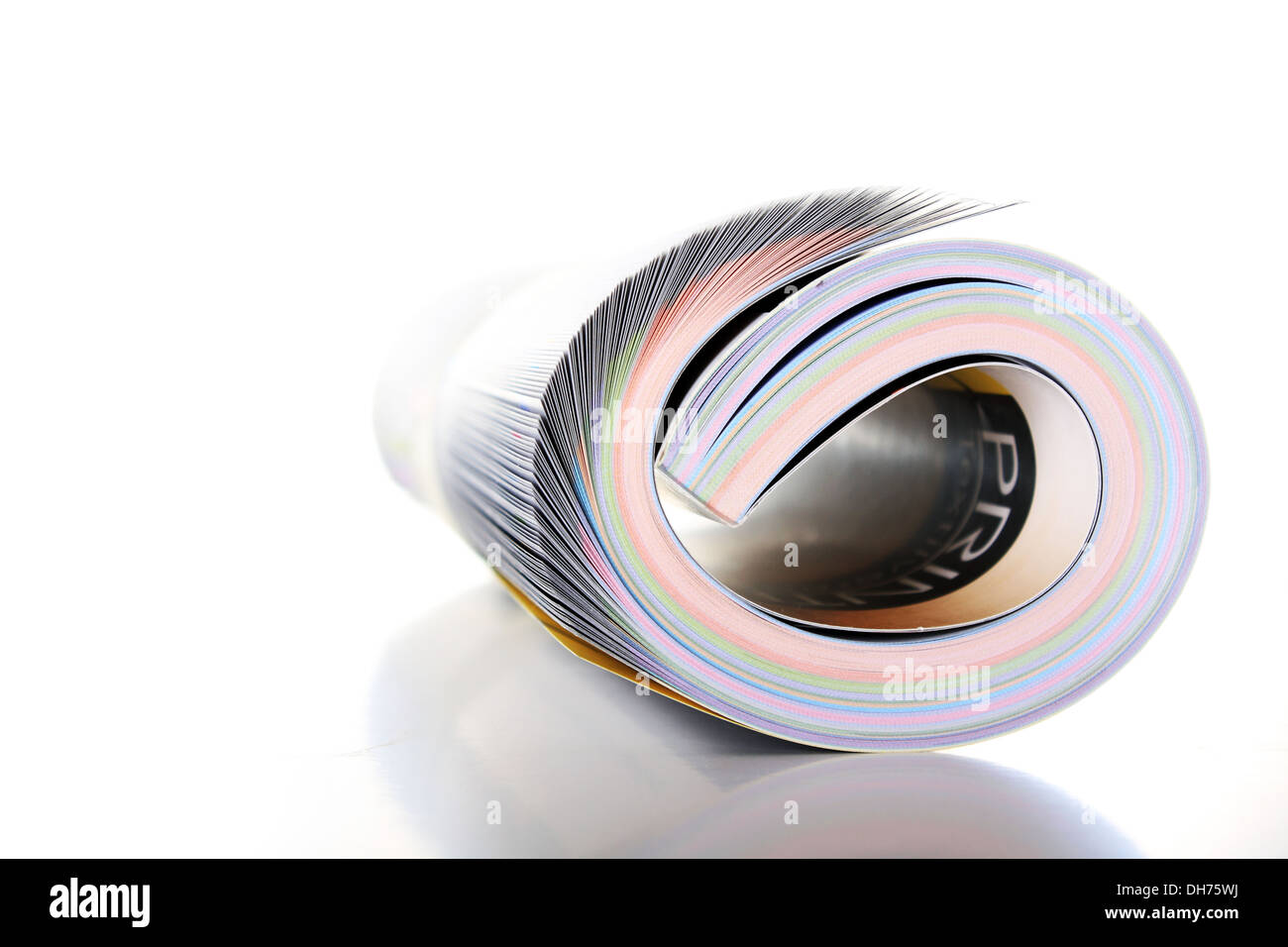 Rolled up magazine over with background Stock Photo - Alamy