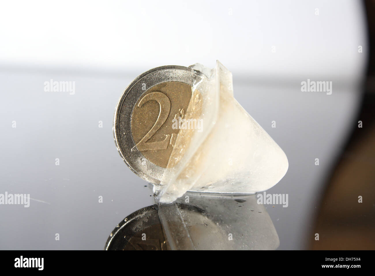 Ice Cube with Euro Coin Stock Photo - Alamy