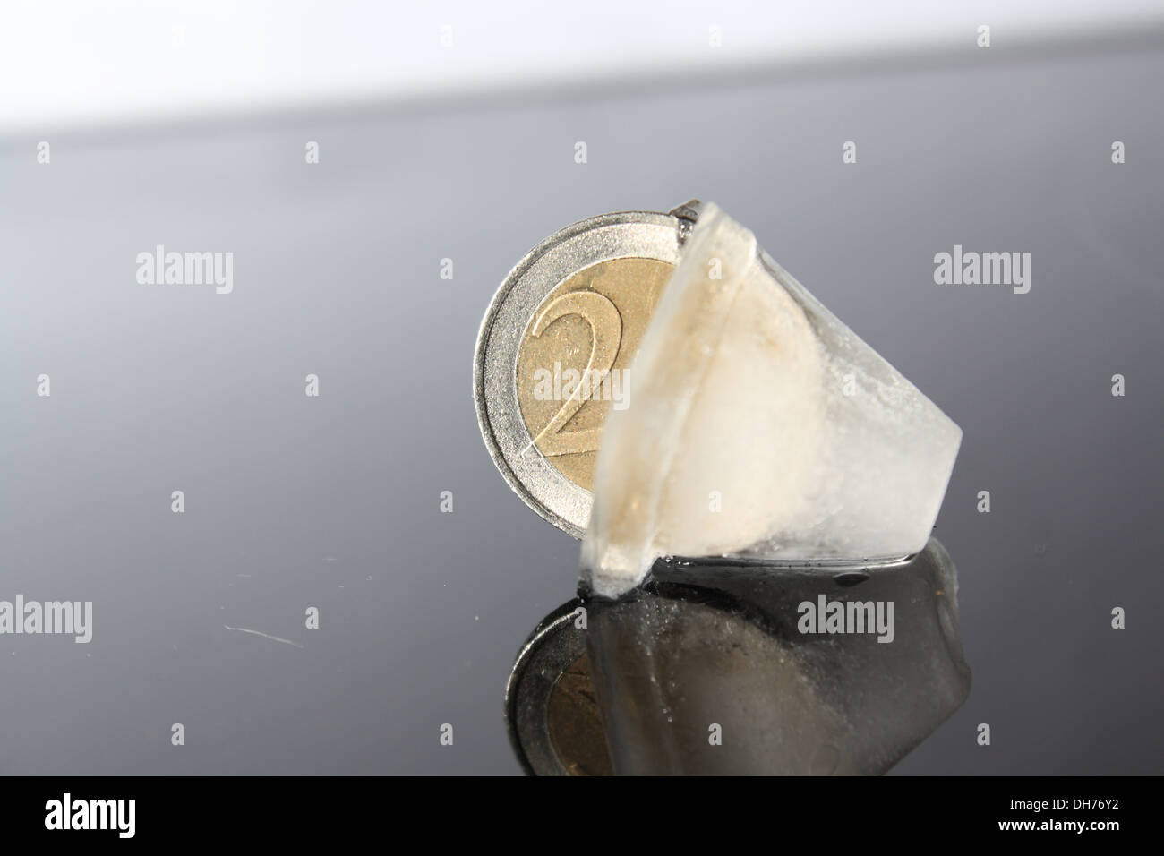 Ice Cube with Euro Coin Stock Photo - Alamy