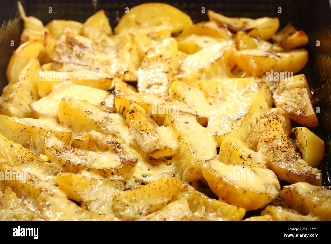 Roasted potatoes with spices and cheese as background Stock Photo - Alamy