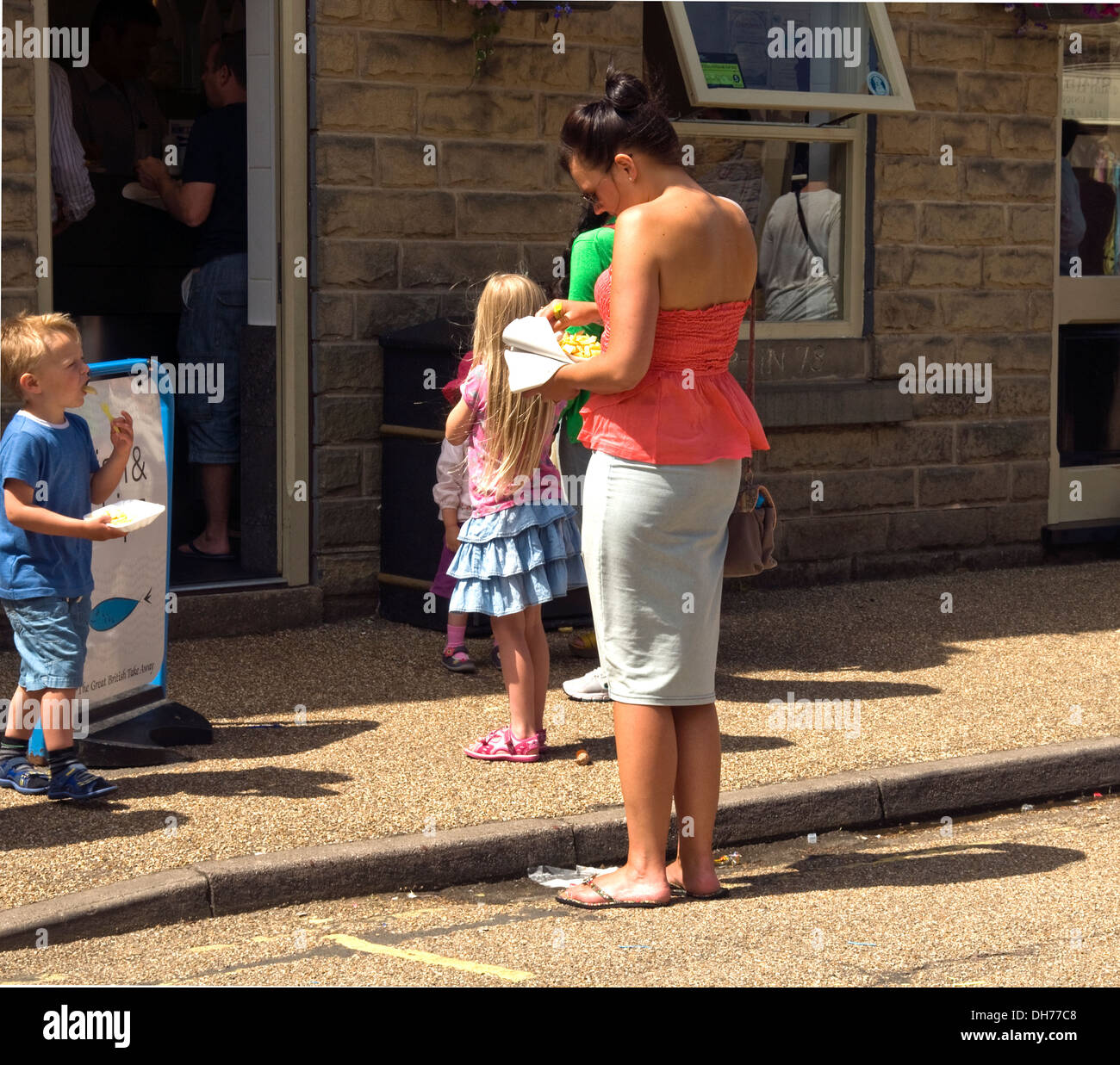 Good-looking-woman at the chip shop eating fish and chips Bakewell ...
