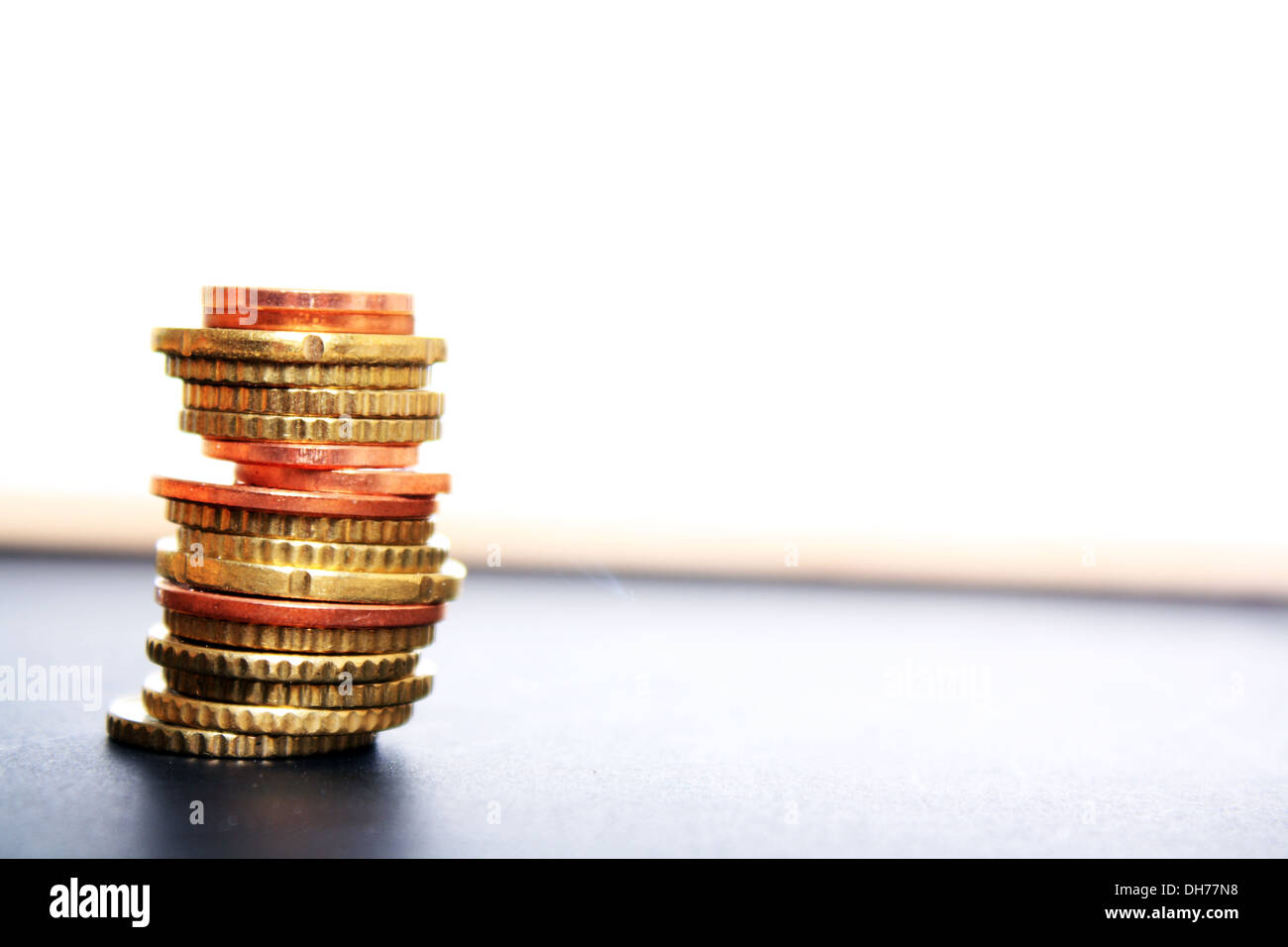 Stack of coin on ground with white background Stock Photo - Alamy