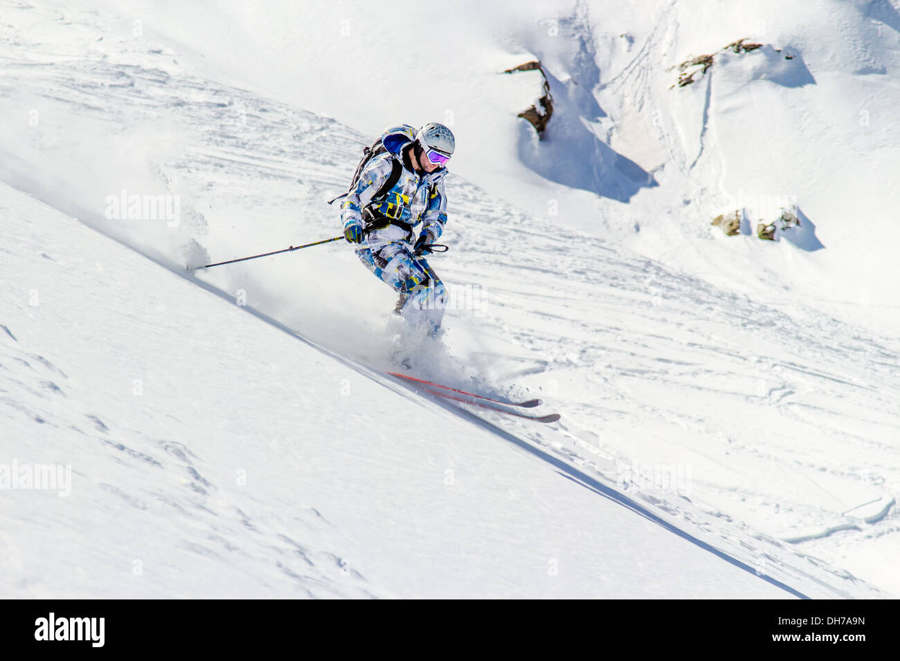Skiing in the sunlight at high speed in a cloud of snow dust Stock ...
