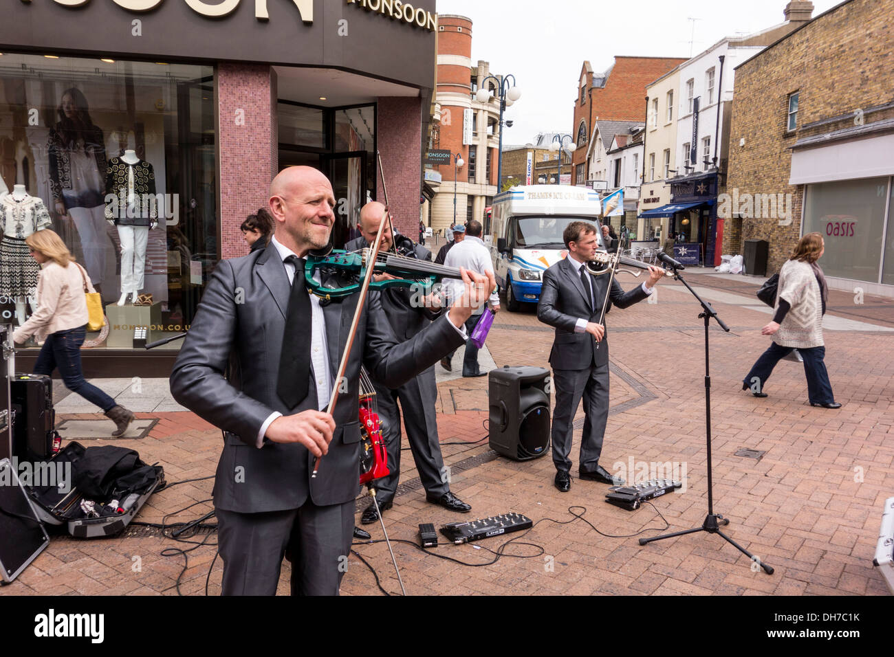 Buskers playing violins in Kingston upon Thames town centre, London, UK ...