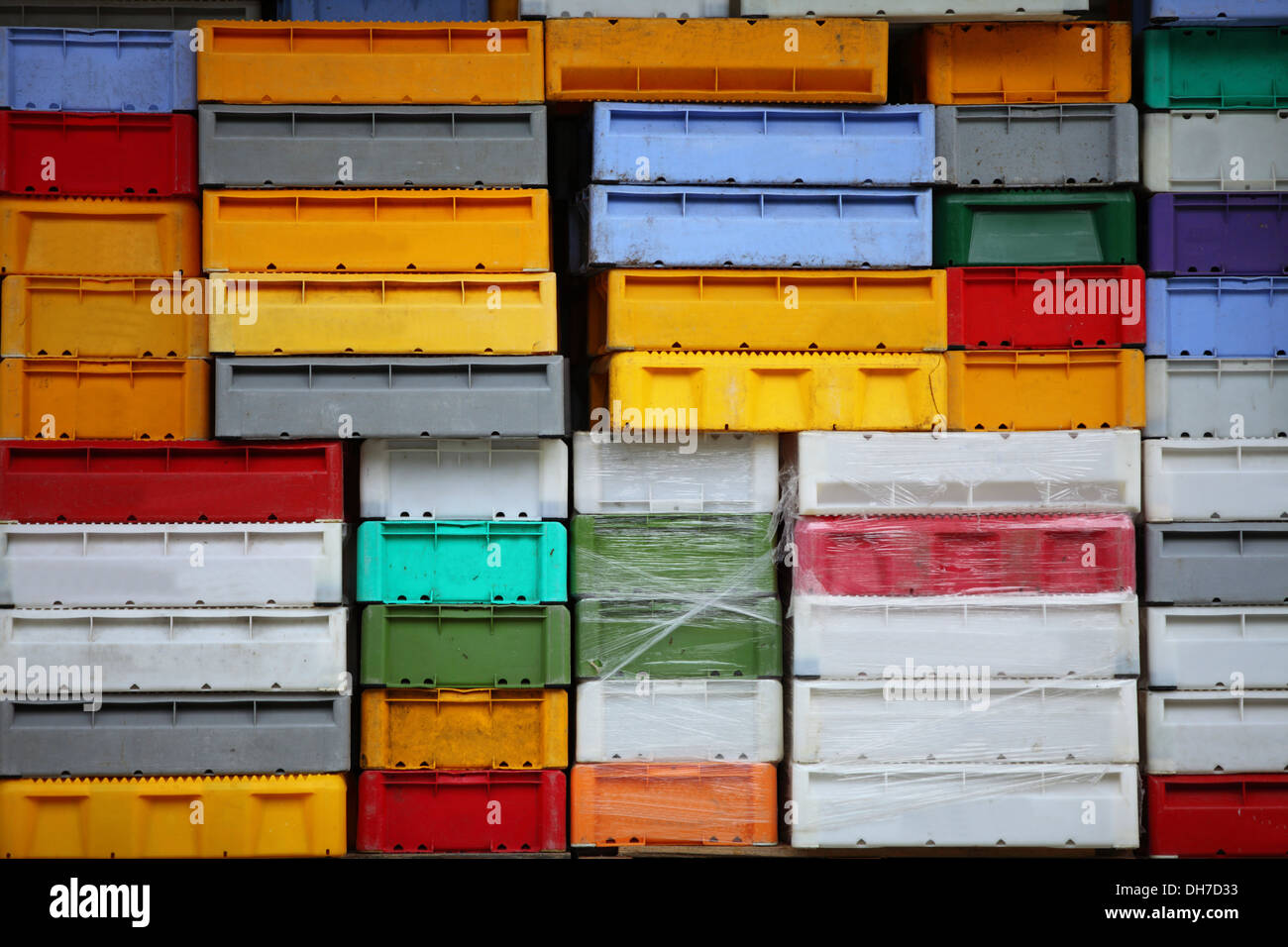 colorful boxes plastic crates background. Packing containers piles for ...