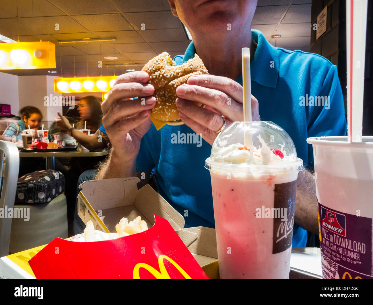 Man Eating at McDonald's Restaurant , Cheesebuger, French Fries and ...