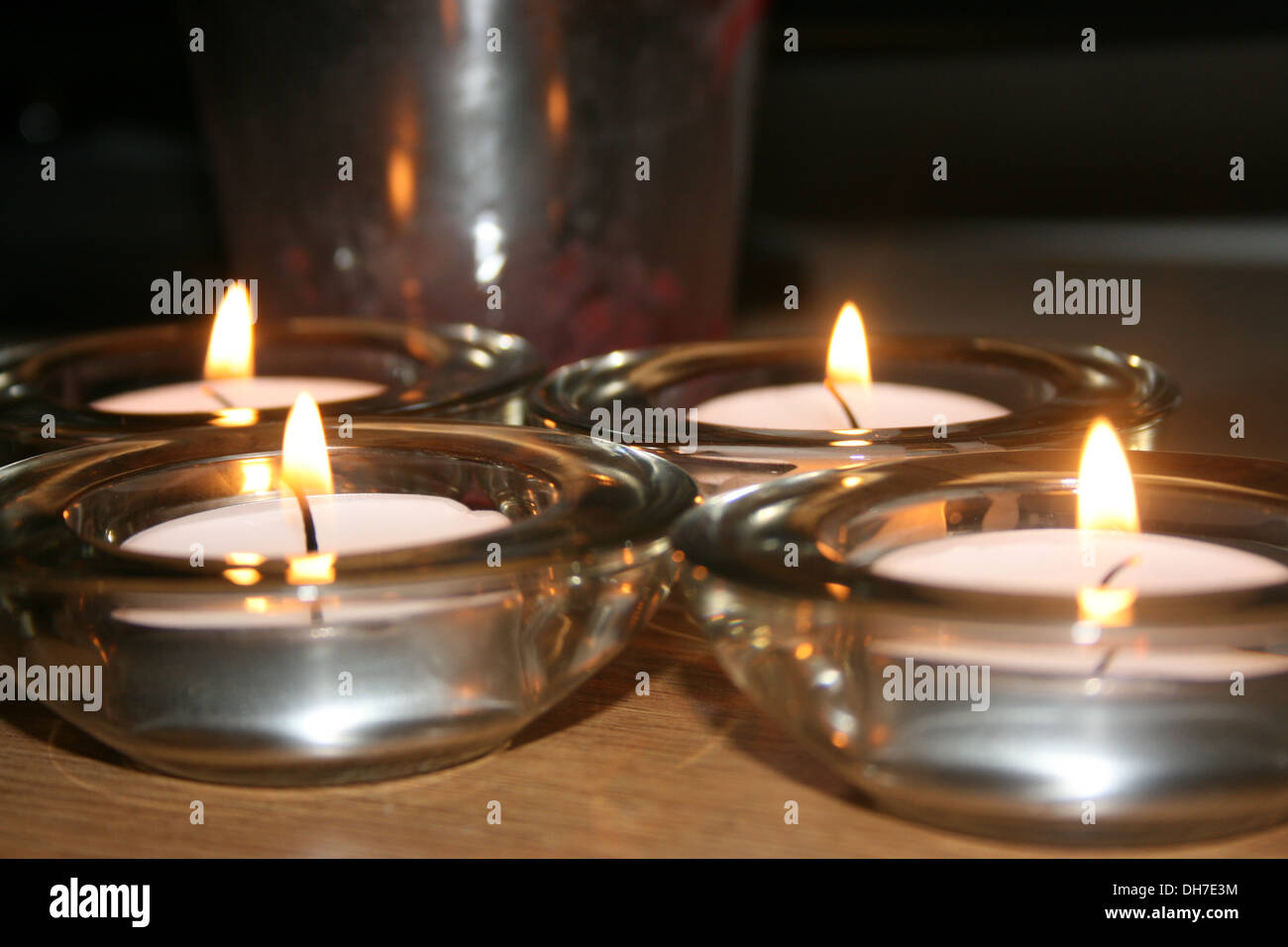Four small lite candles Stock Photo - Alamy