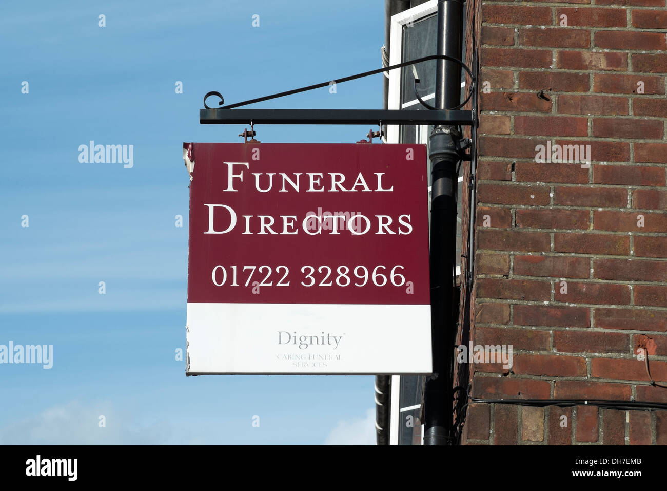 Looking up at UK Funeral Directors sign Stock Photo - Alamy