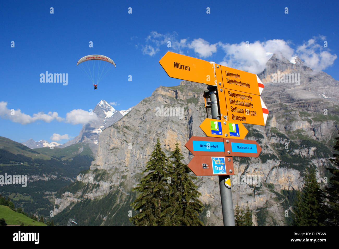 Hang glider soaring over the snow capped peaks of the Swiss Alps ...