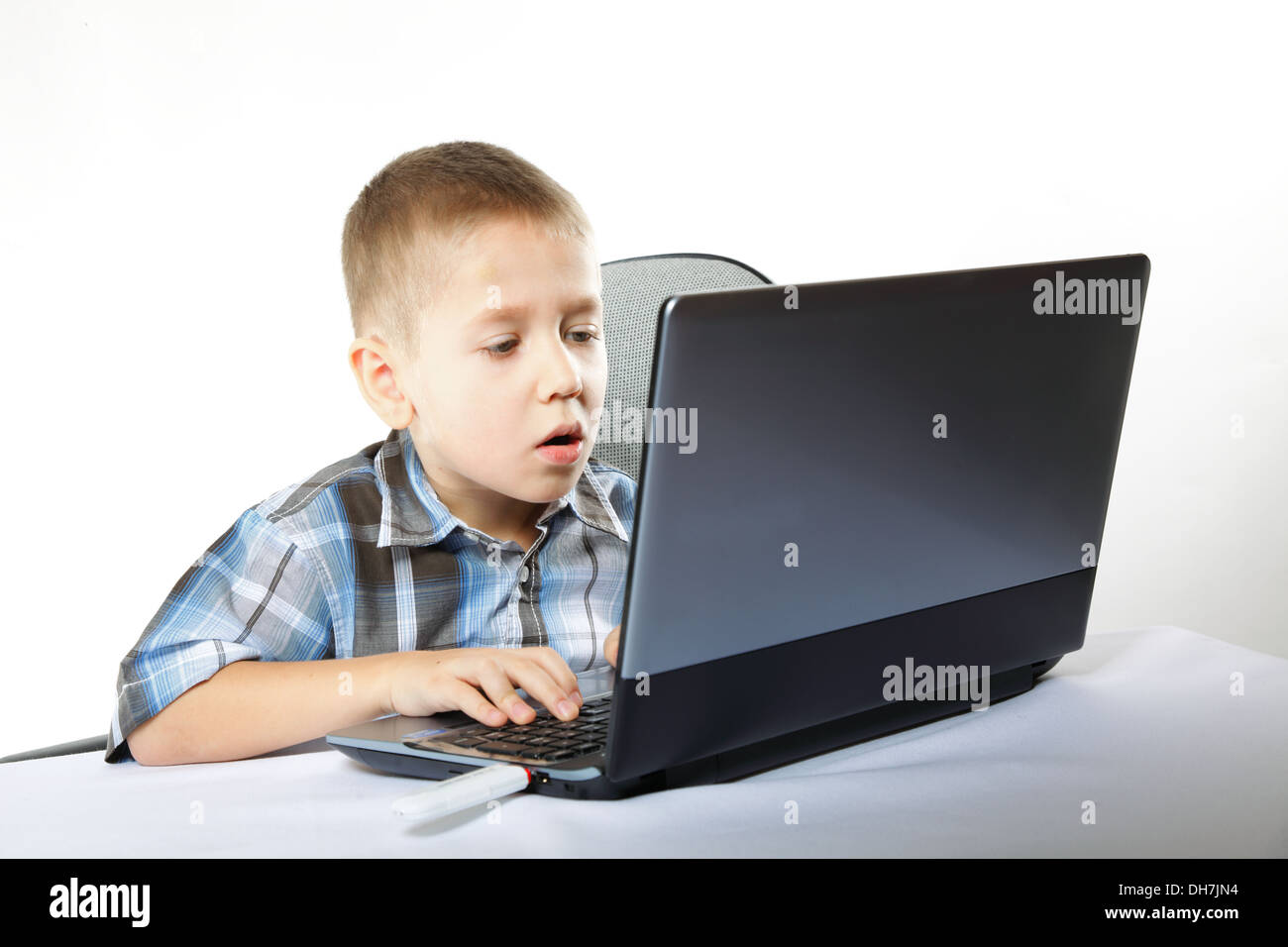 Computer addiction child boy with laptop notebook white background ...