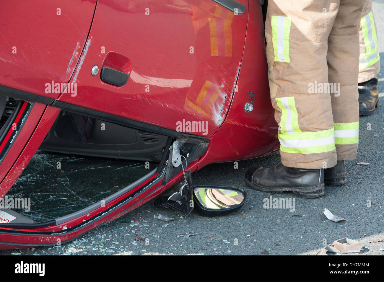 Car on roof crashed fireman RTA RTC firemen crush Stock Photo - Alamy
