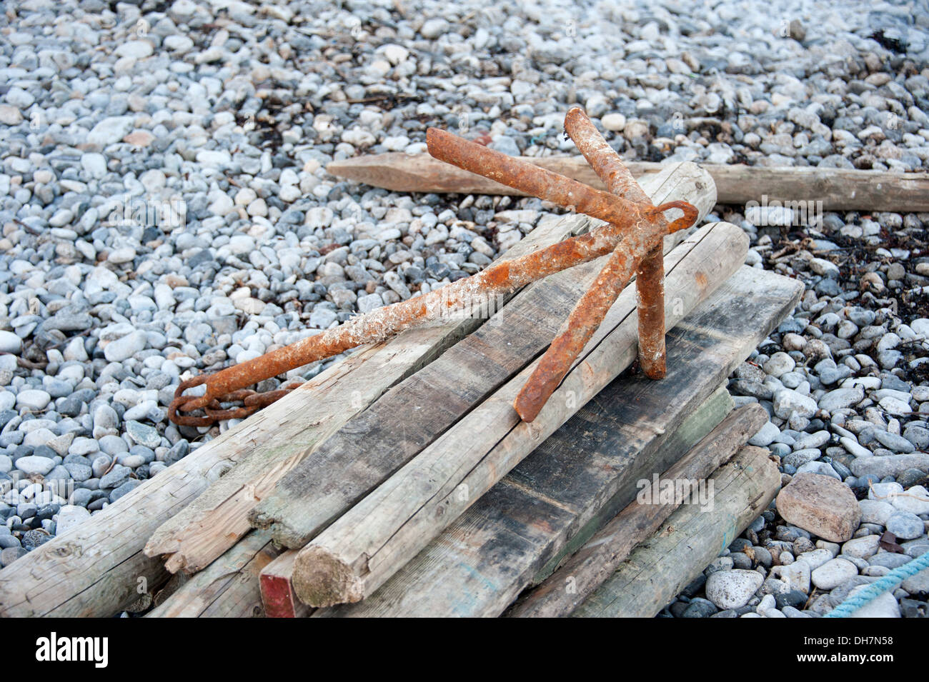 Rusty boat ship steel anchor on seashore beach stones Stock Photo - Alamy