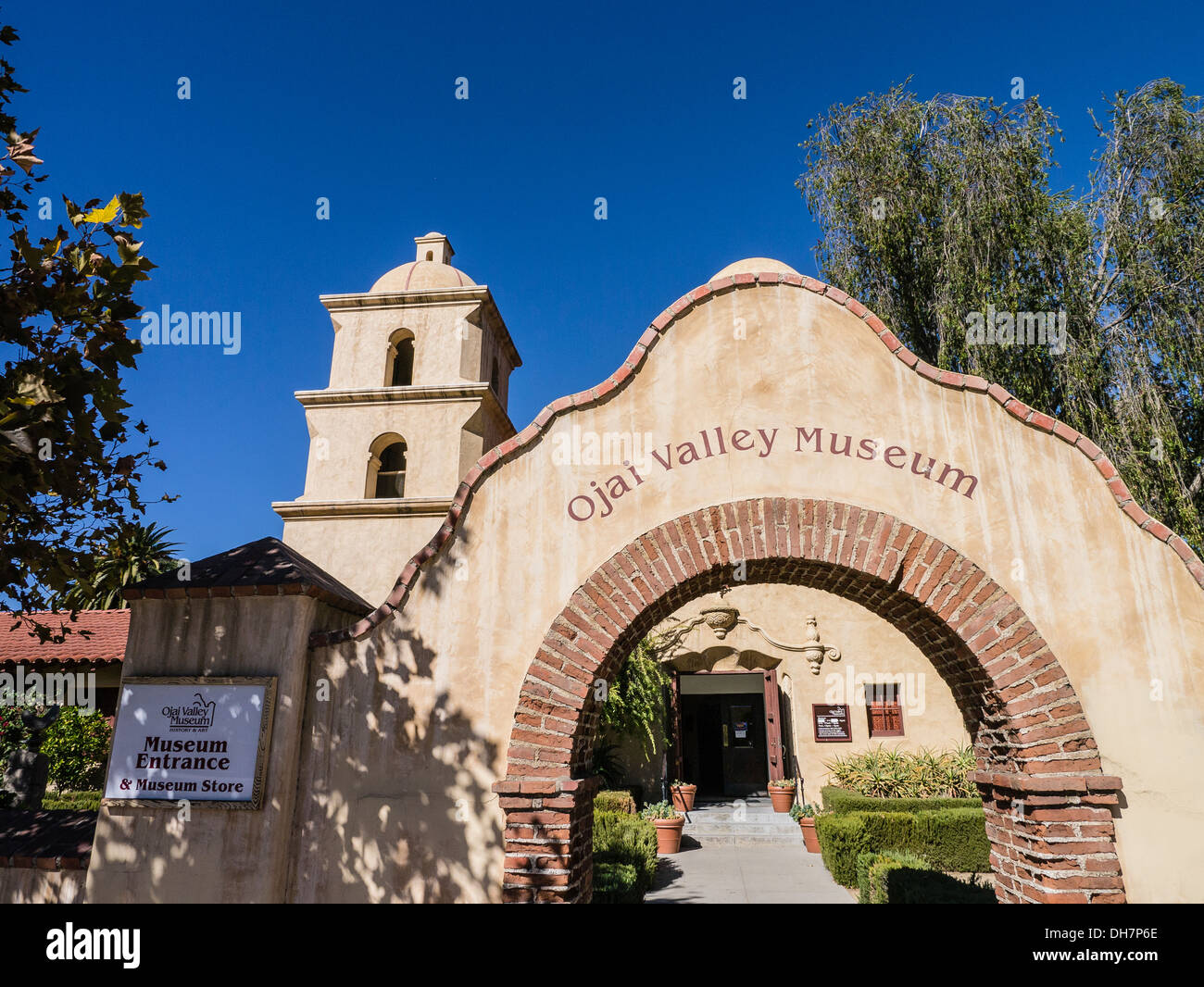 Archway entrance to Ojai Valley Museum framing the bell tower and cross ...
