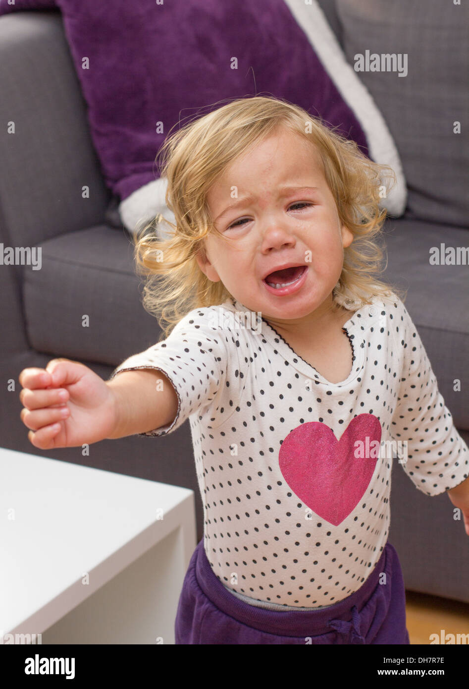 Sad unhappy crying little girl indoor Stock Photo - Alamy