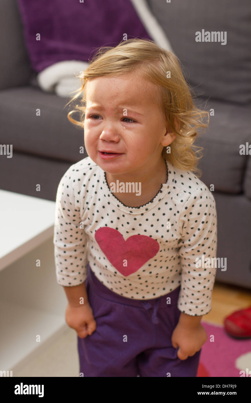 Sad unhappy crying little girl indoor Stock Photo - Alamy