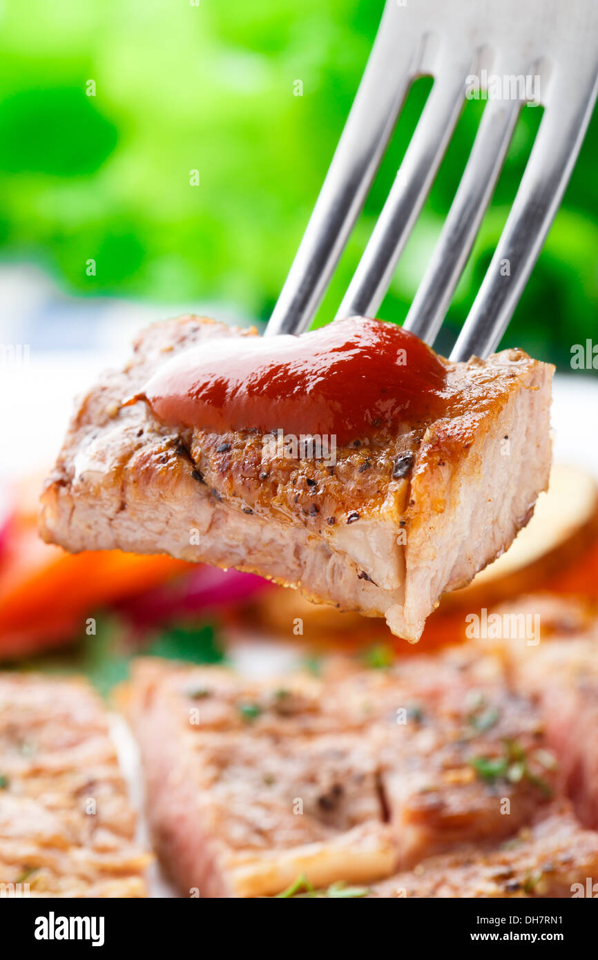 Piece of steak on fork Stock Photo - Alamy