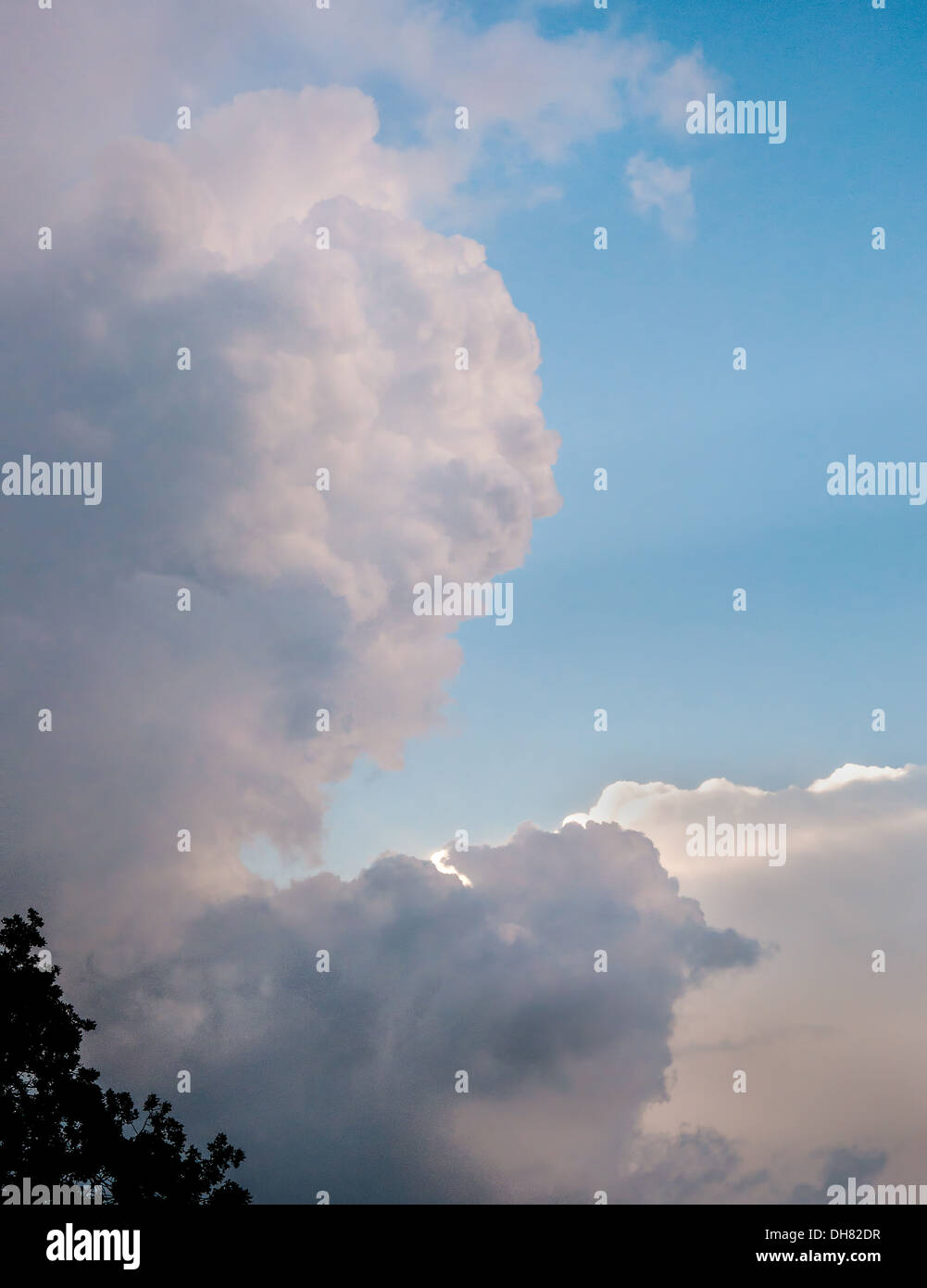 Storm clouds rolling past clear skies Stock Photo - Alamy