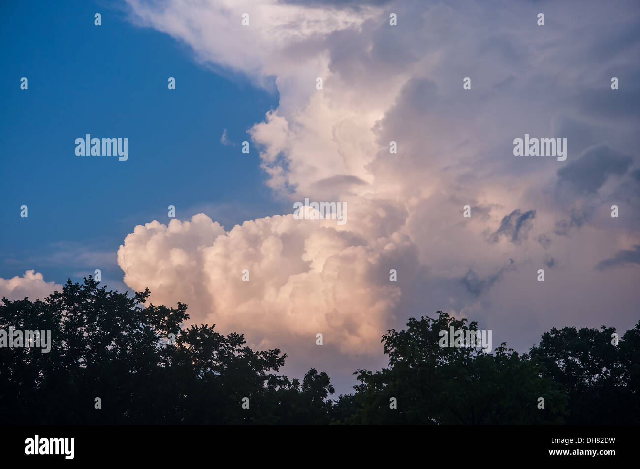 Storm clouds rolling past clear skies Stock Photo - Alamy