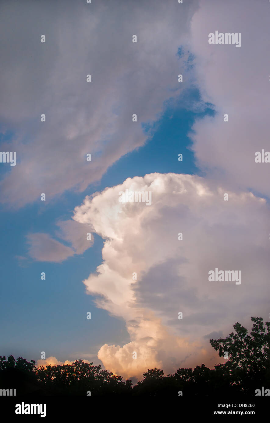 Storm clouds rolling past clear skies Stock Photo - Alamy