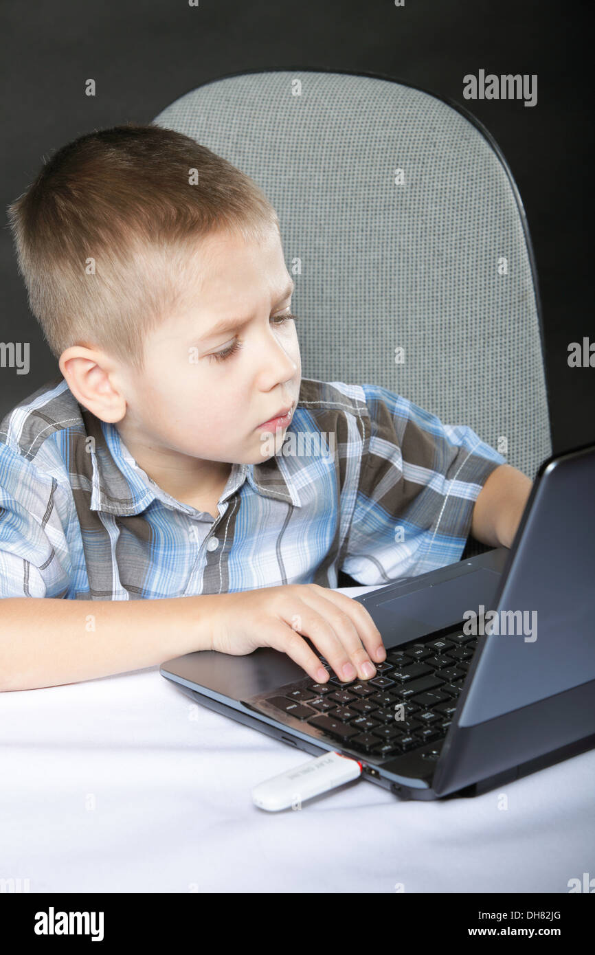 Computer addiction child boy with laptop notebook black background ...