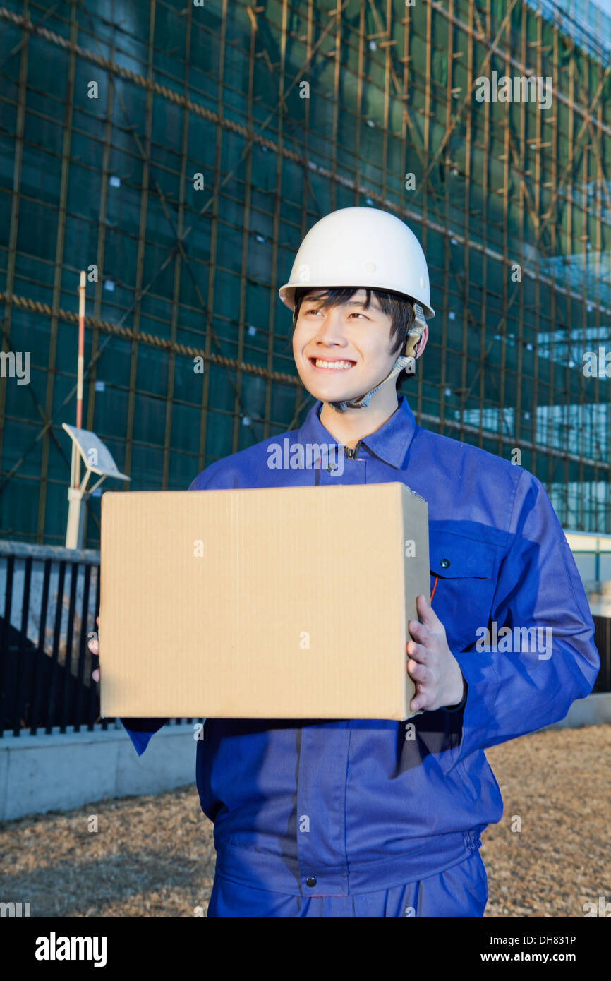 Logistics staff at the site holding the goods Stock Photo - Alamy