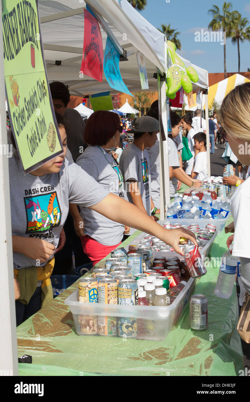 People handing out water soft drinks and healthy sodas at the end of ...