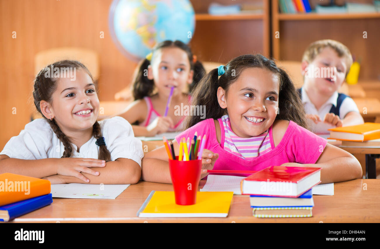 Happy schoolchildren during lesson in classroom at school Stock Photo ...