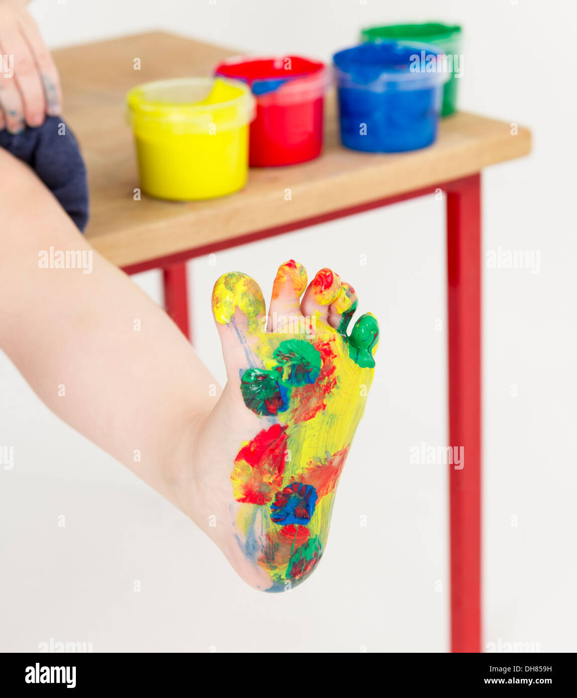 painted foot with color tubs in background Stock Photo - Alamy