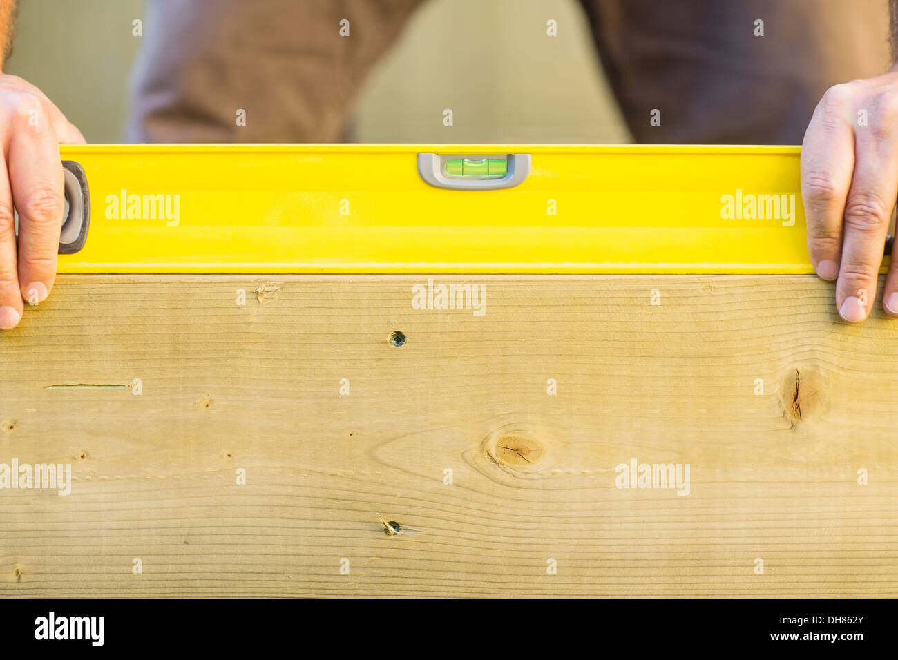 Worker Holding Spirit Level On Wood Outdoors Stock Photo - Alamy