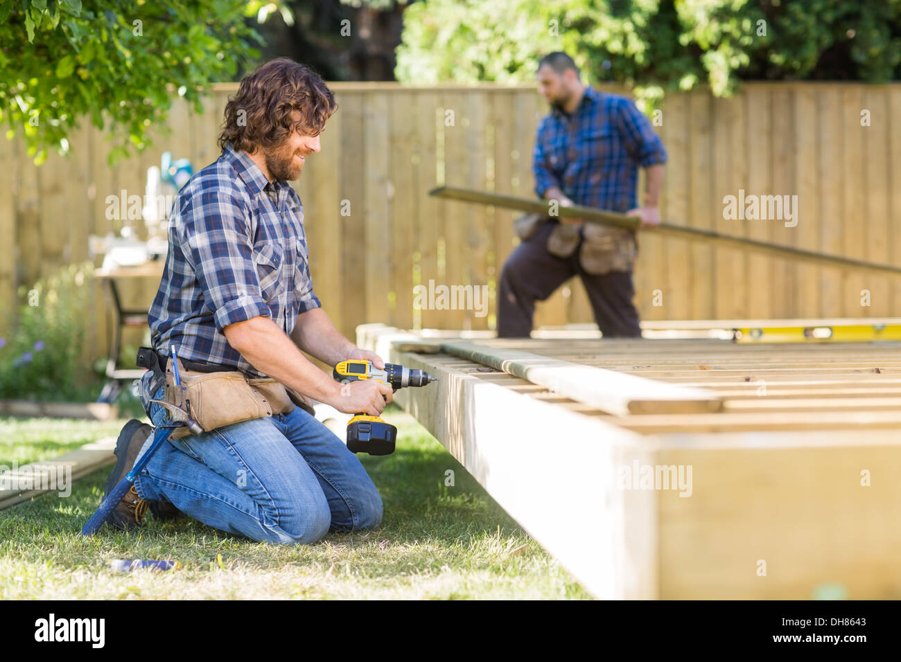 Manual Worker Drilling Wood At Construction Site Stock Photo - Alamy
