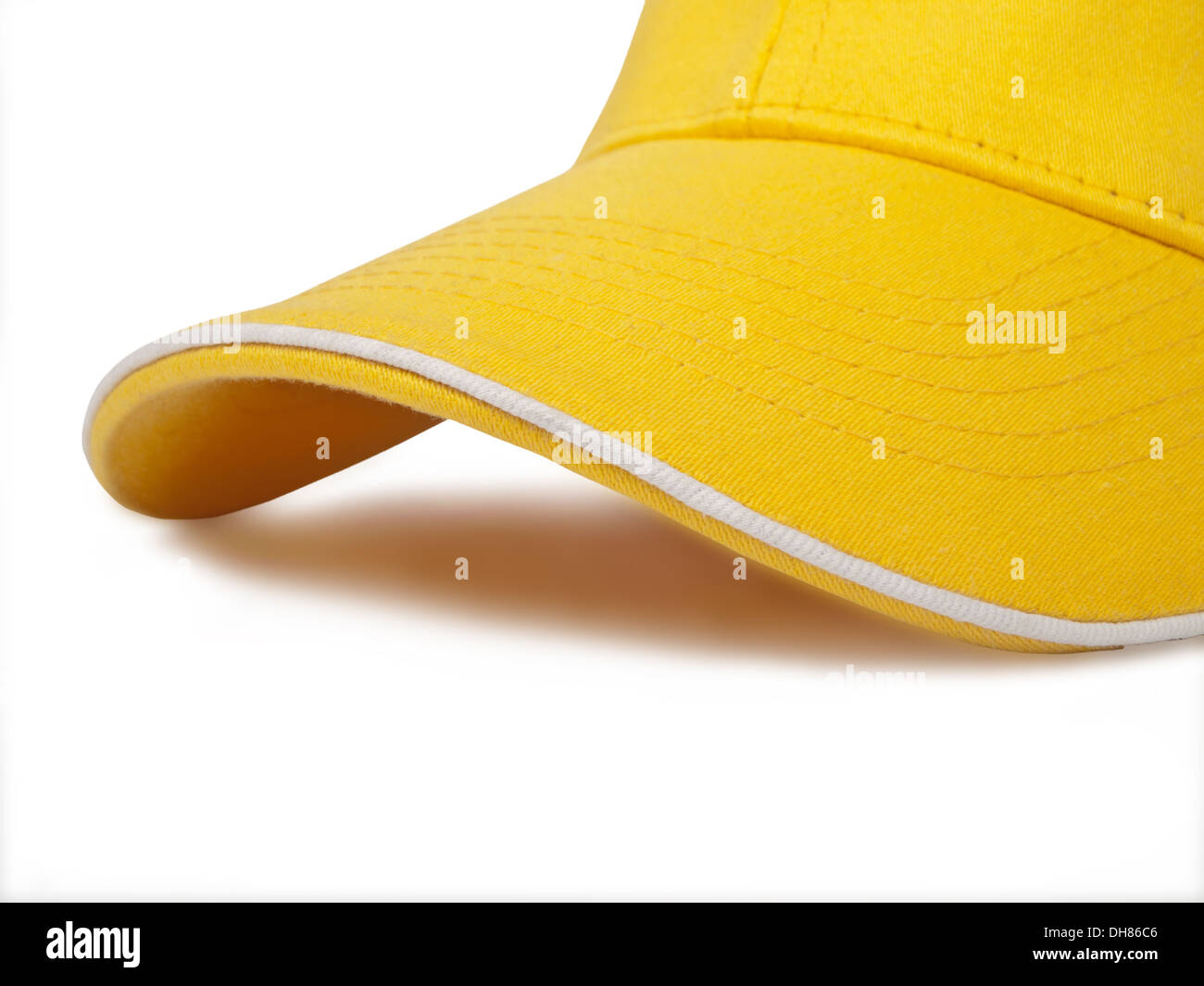 detail of yellow cap isolated on white background Stock Photo - Alamy
