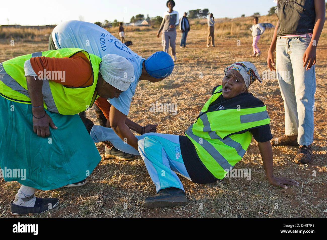 A members of the Orange Farm grandmother's team is given first aid ...