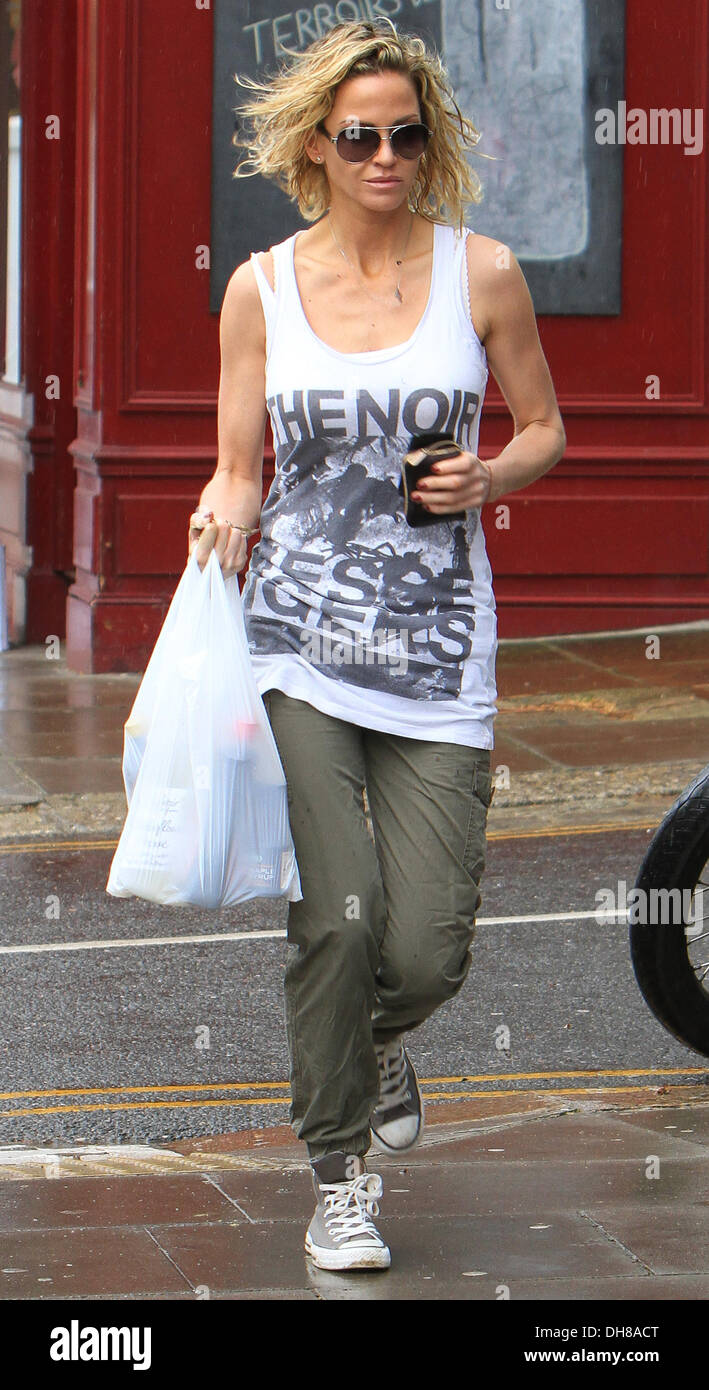 Sarah Harding gets caught in the rain while wearing just a vest as she ...